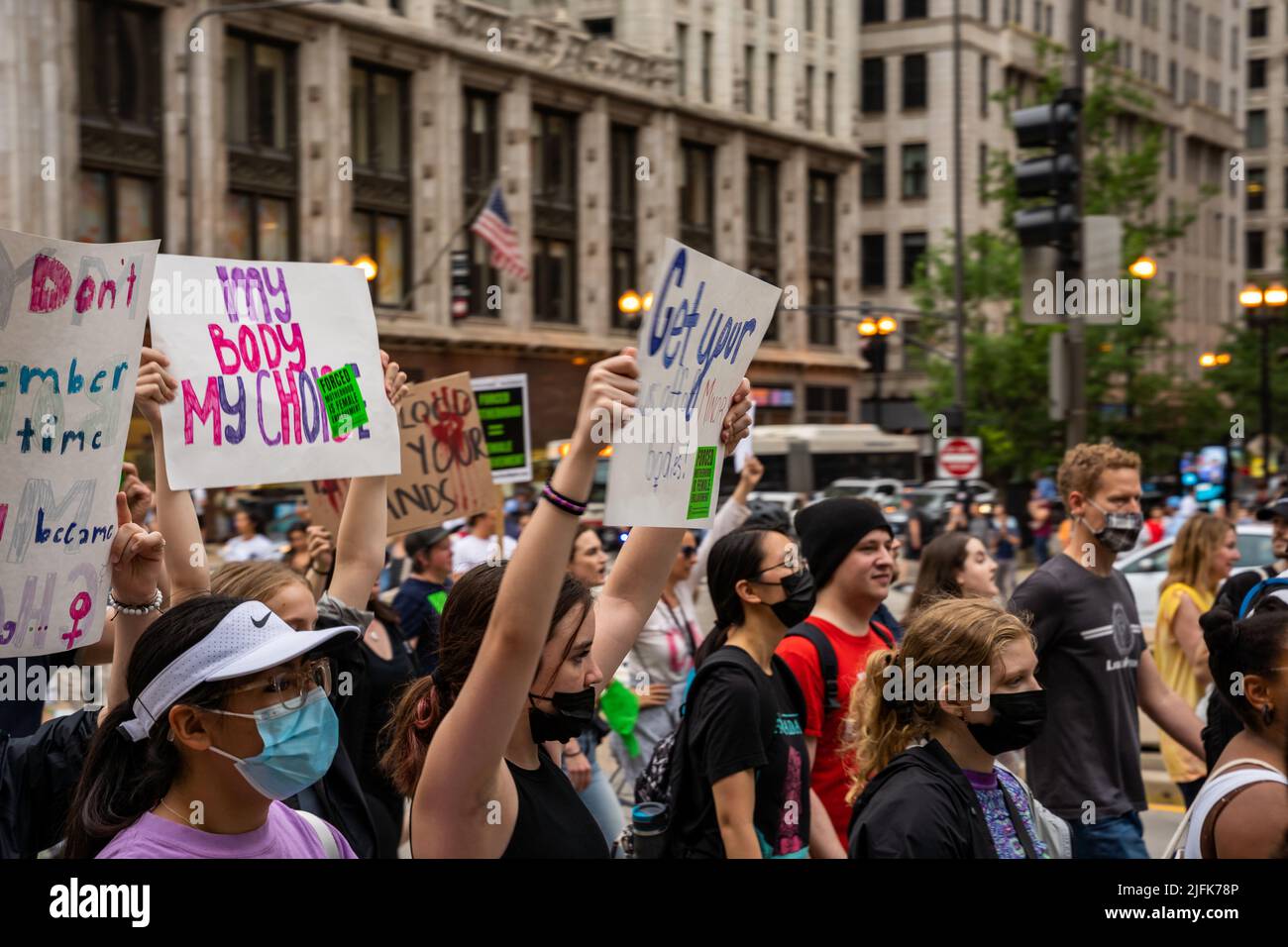 Protesters holding signs My Body My Choice, Ban bombs not Bodies ...