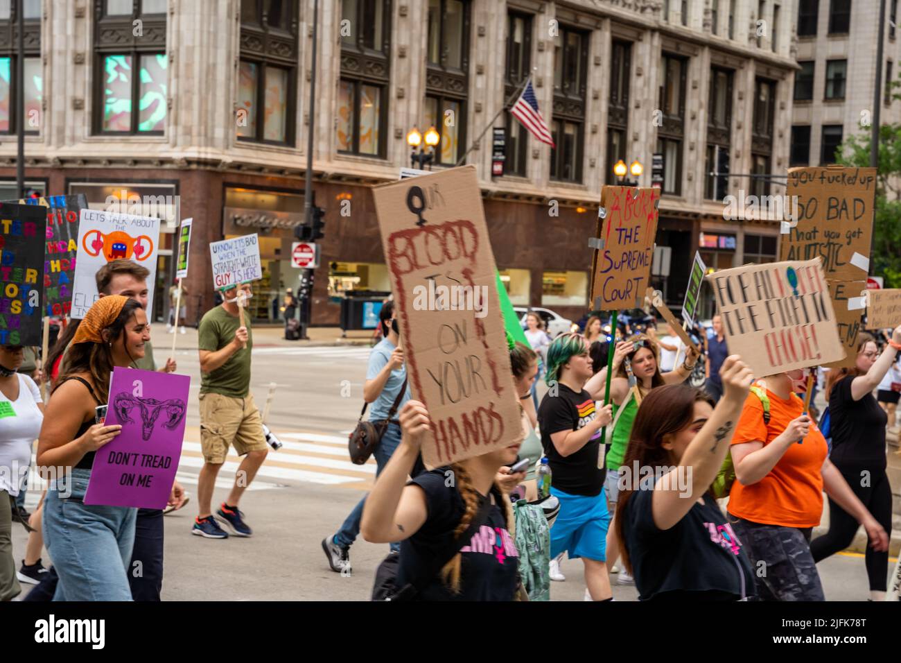 Protesters holding signs My Body My Choice, Ban bombs not Bodies ...