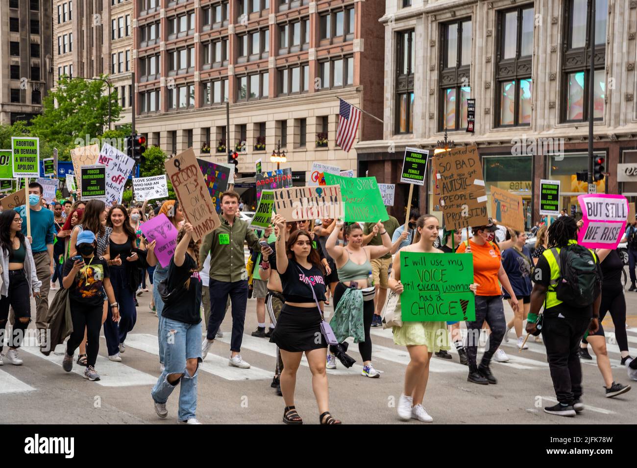 Protesters holding signs My Body My Choice, Ban bombs not Bodies ...