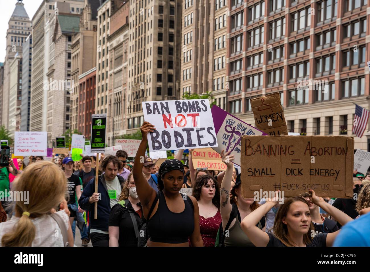 Protesters holding signs My Body My Choice, Ban bombs not Bodies ...