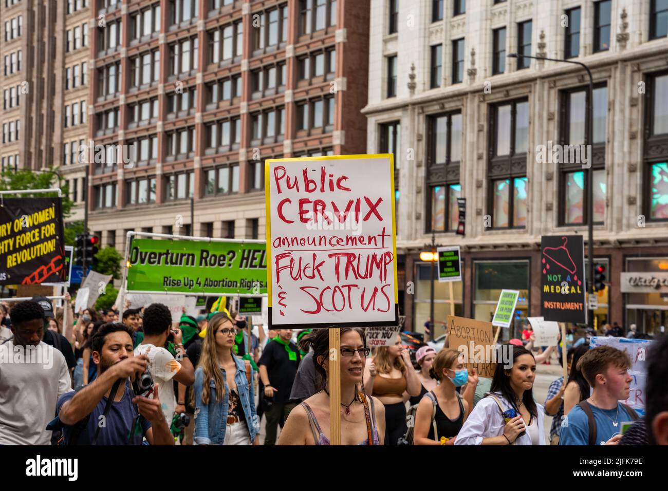 Protesters holding signs My Body My Choice, Ban bombs not Bodies ...