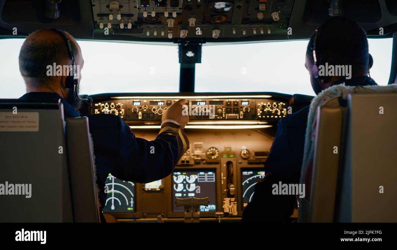 Diverse team of aviators preparing to takeoff with airplane, fixing ...