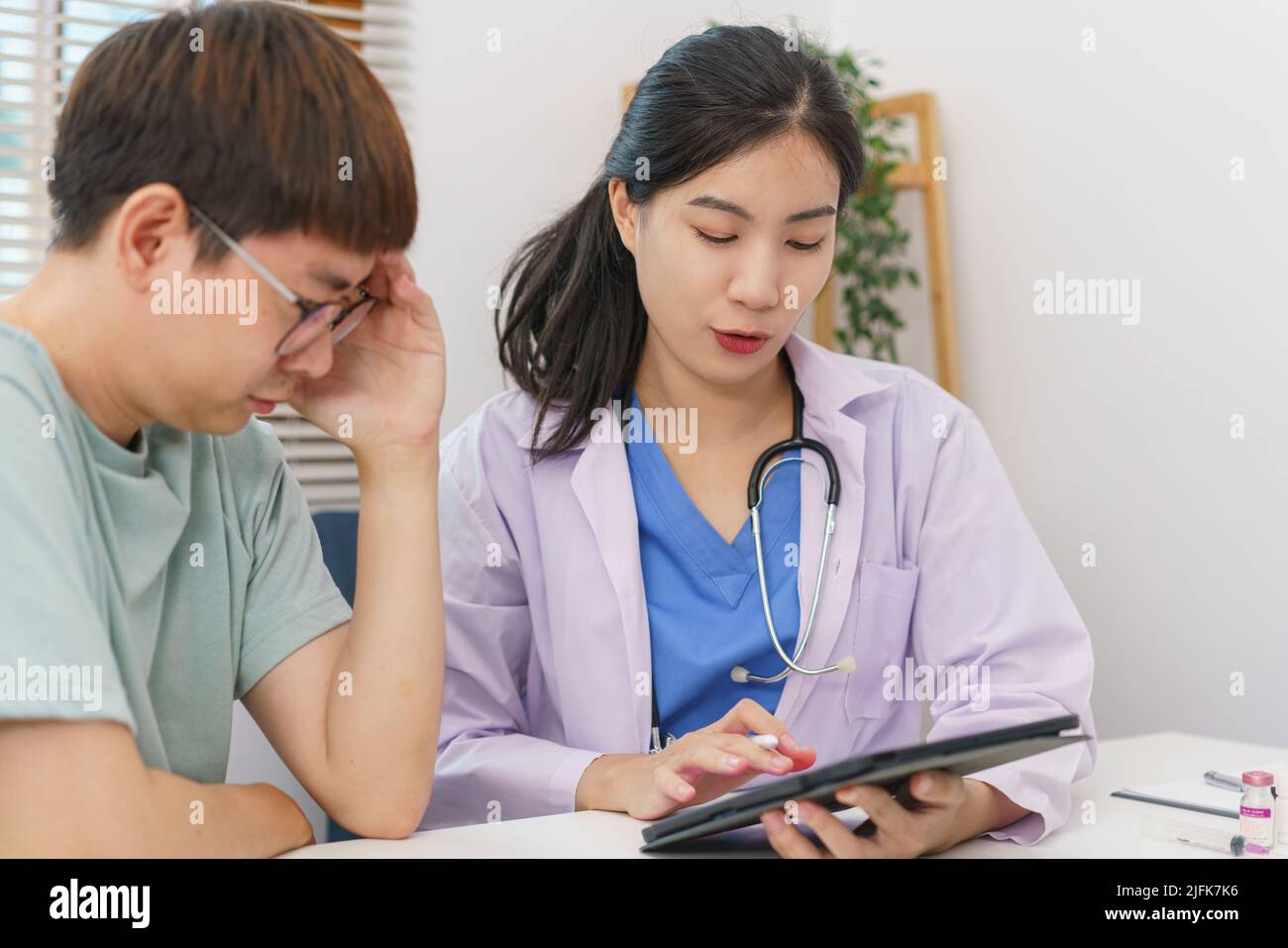 Healthcare concept, Male patient feeling headache and talk with doctor ...