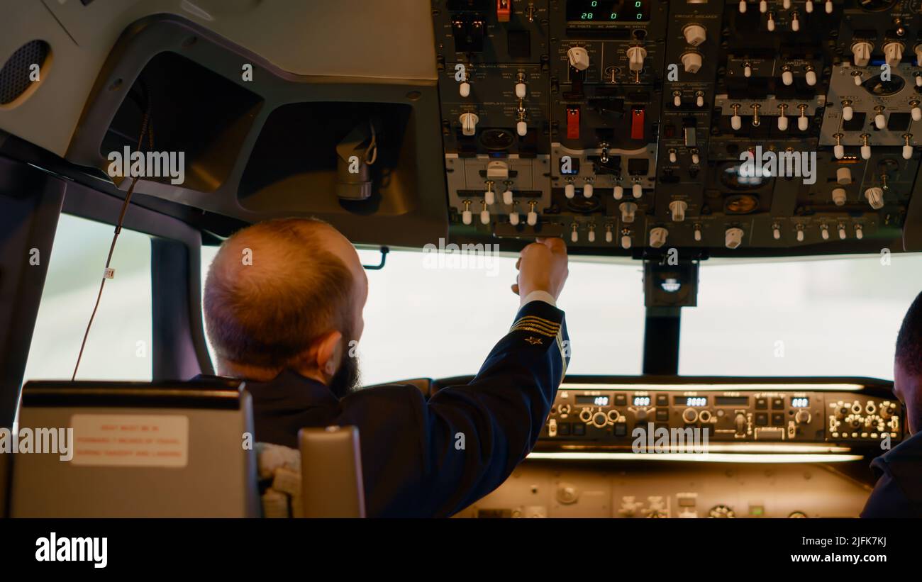 Flying aircrew preparing to takeoff with airplane in cockpit, using ...