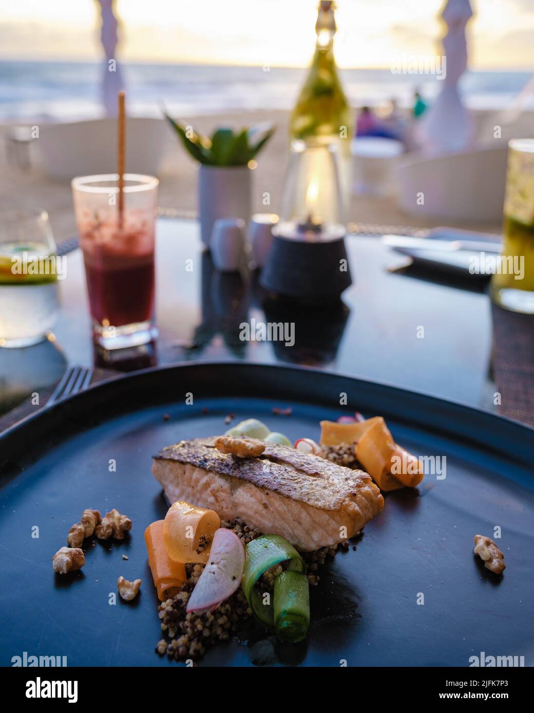 Grilled Salmon, Dinner during sunset on the beach in Phuket Thailand ...