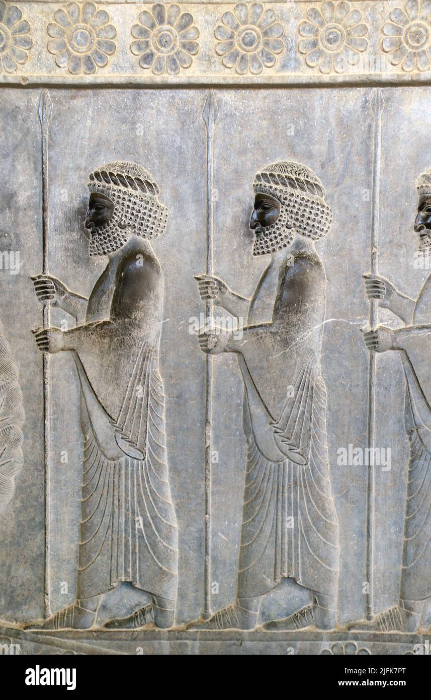 Ancient wall with bas-relief with assyrian warriors with spears ...