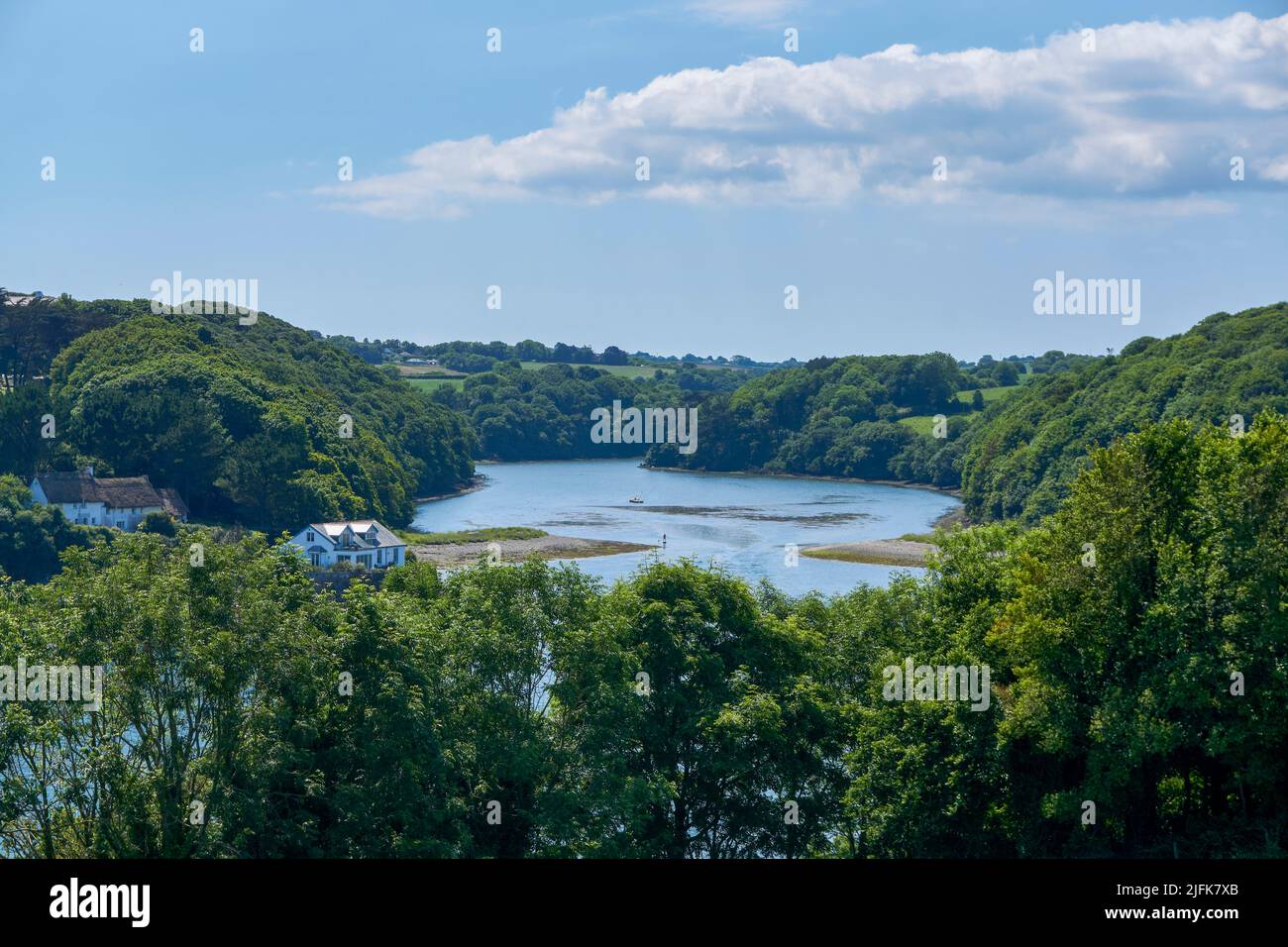 Gillan Harbour, with a paddleboarder and houses at Gillan and Flushing ...