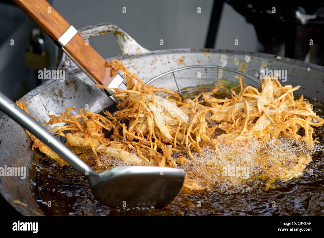 Frying shredded taro in hot oil. Cooking crispy shredded taro ...