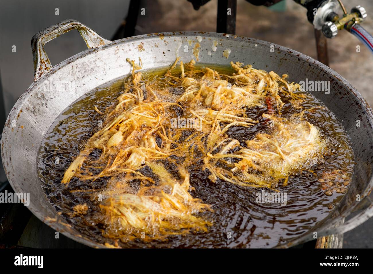 Frying shredded taro in hot oil. Cooking crispy shredded taro ...