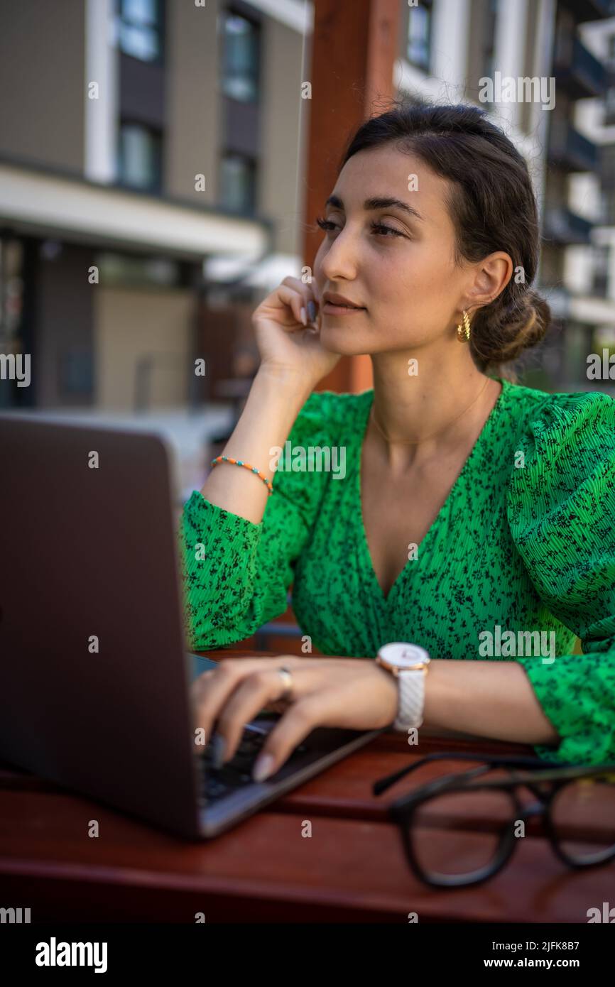 Caucasian woman working with laptop computer outside office Stock Photo ...