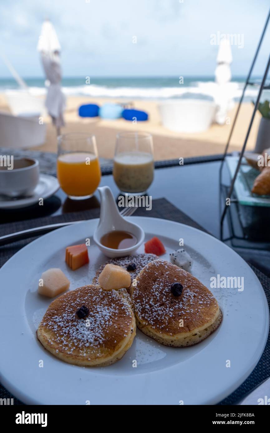 Pancakes and fruit, Breakfast on the beach in Phuket Thailand, a Luxury ...