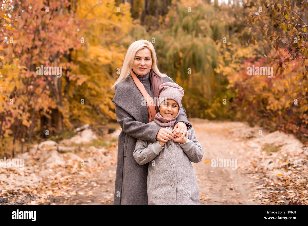 happy family mother and child daughter play and laugh at the autumn walk. Mother and child ...