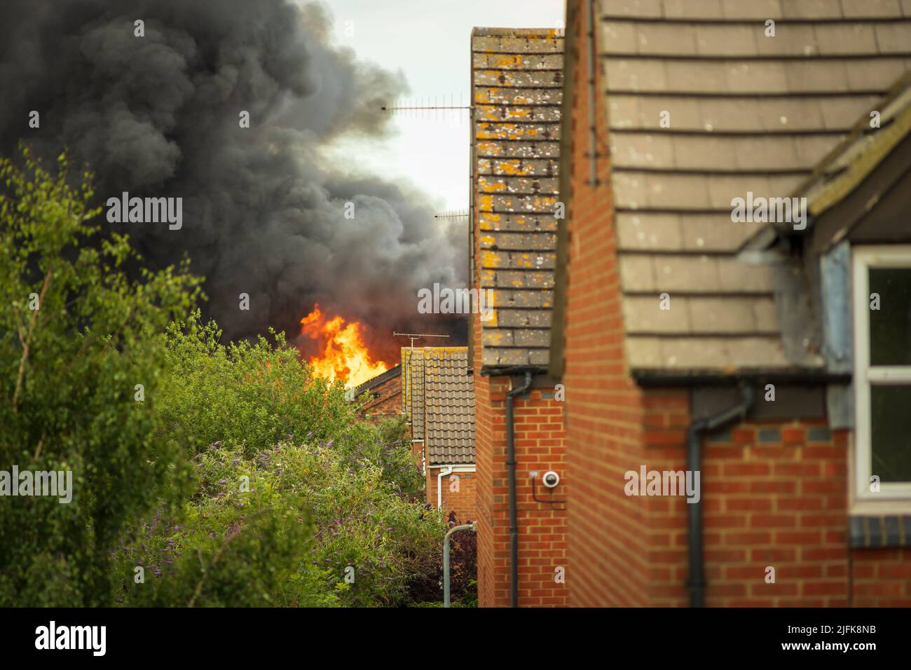 House roof on fire in england uk Stock Photo - Alamy