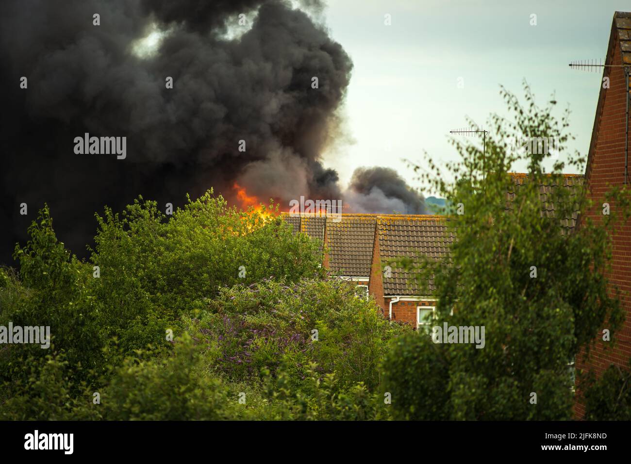 House roof on fire in england uk Stock Photo - Alamy