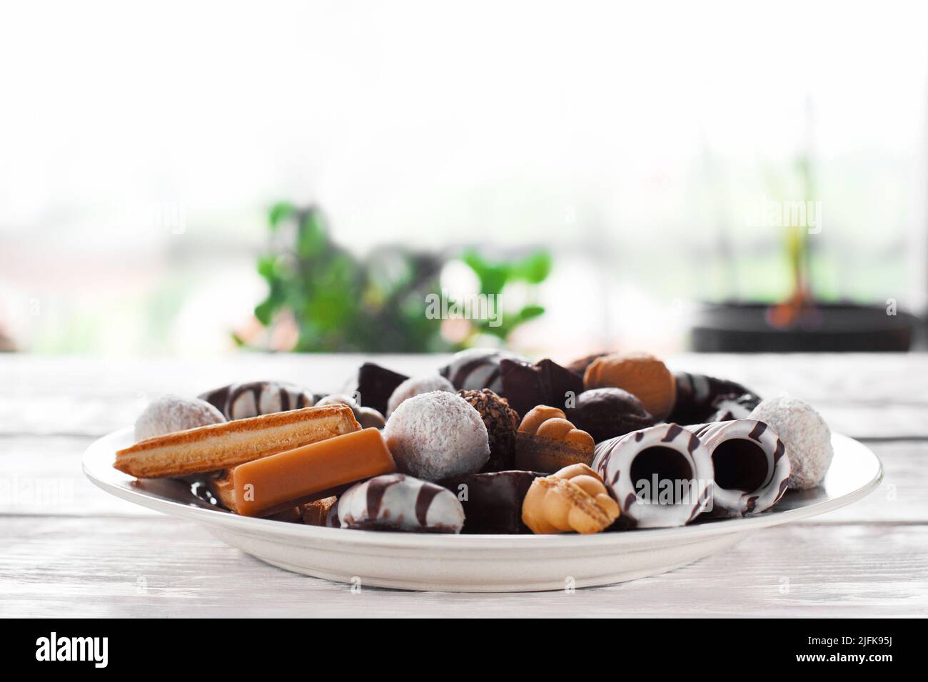 Sweet chocolate candies on table side view Stock Photo - Alamy