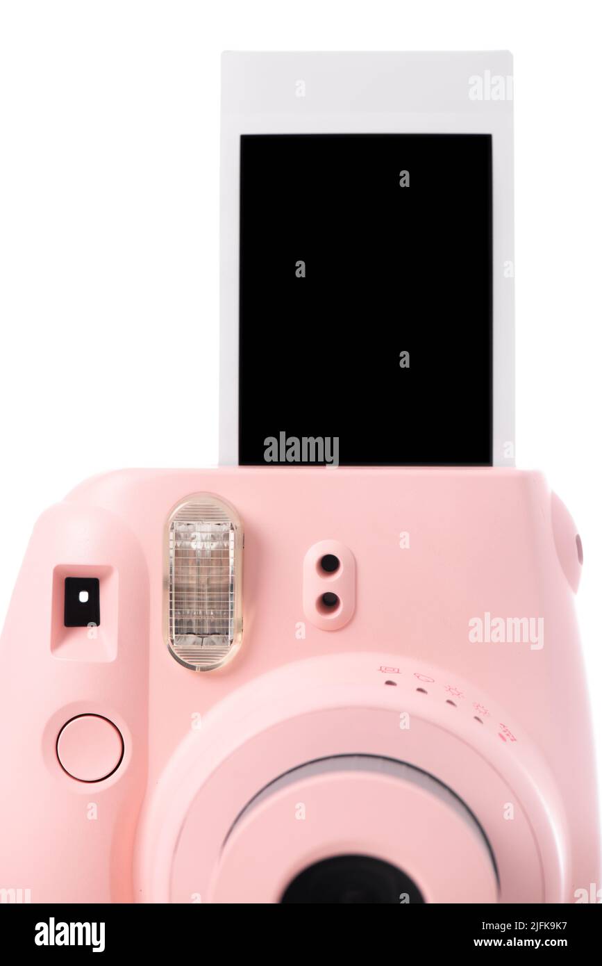 The pink instant camera with blank instant films over white background ...