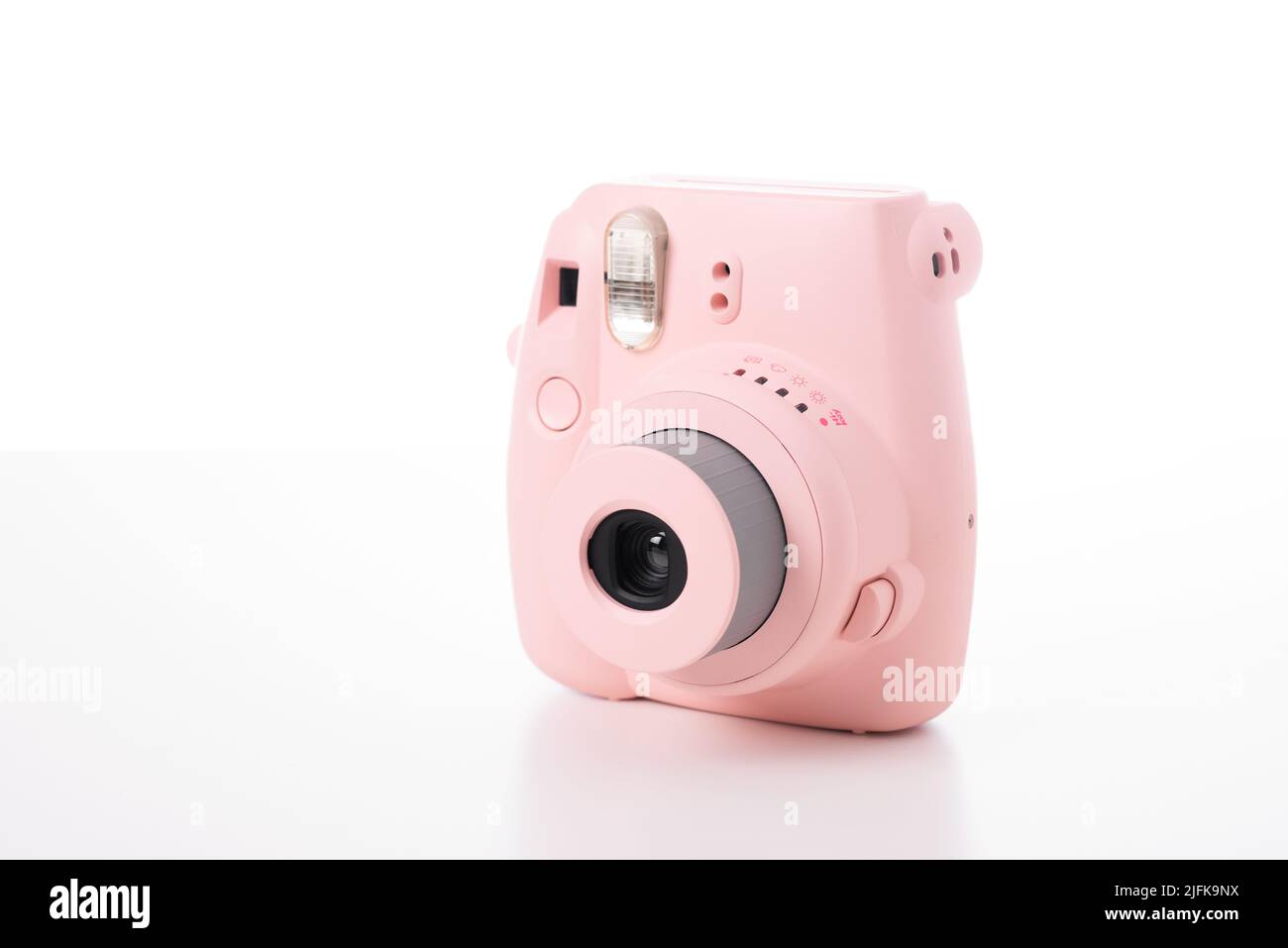 The pink instant camera over white background Stock Photo - Alamy