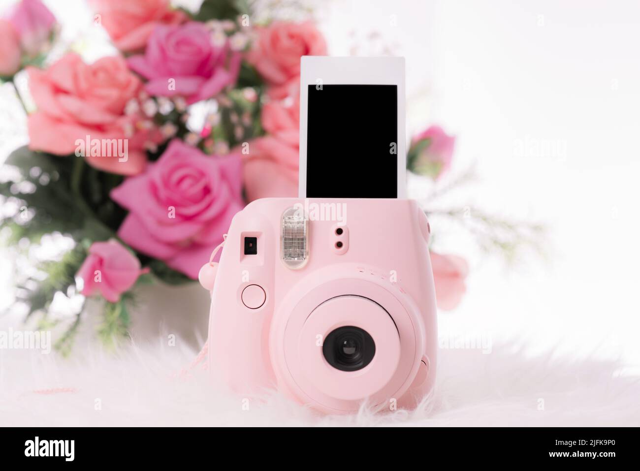 The pink instant camera with blank instant films Stock Photo - Alamy