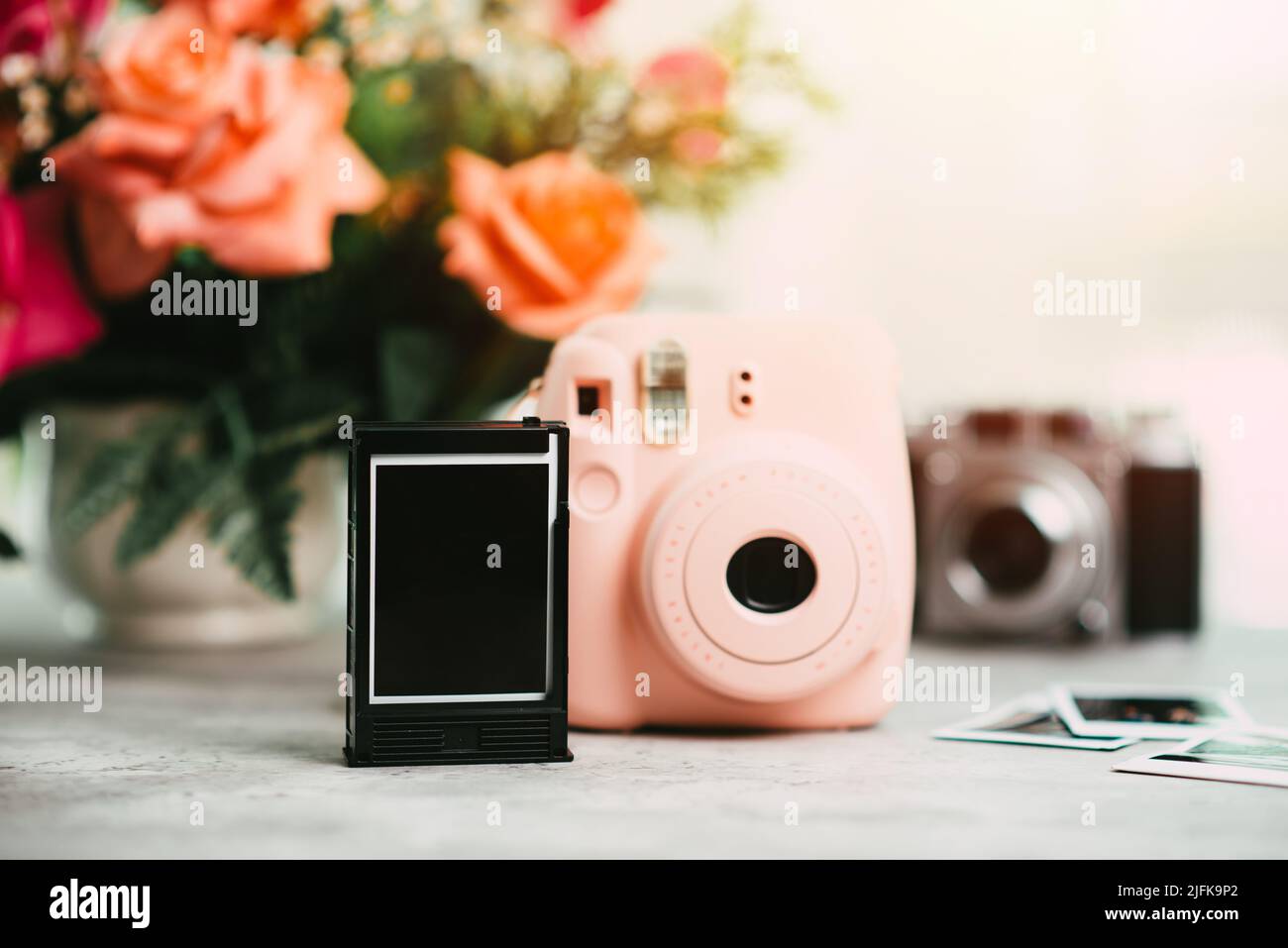 The pink instant camera with blank instant films Stock Photo - Alamy