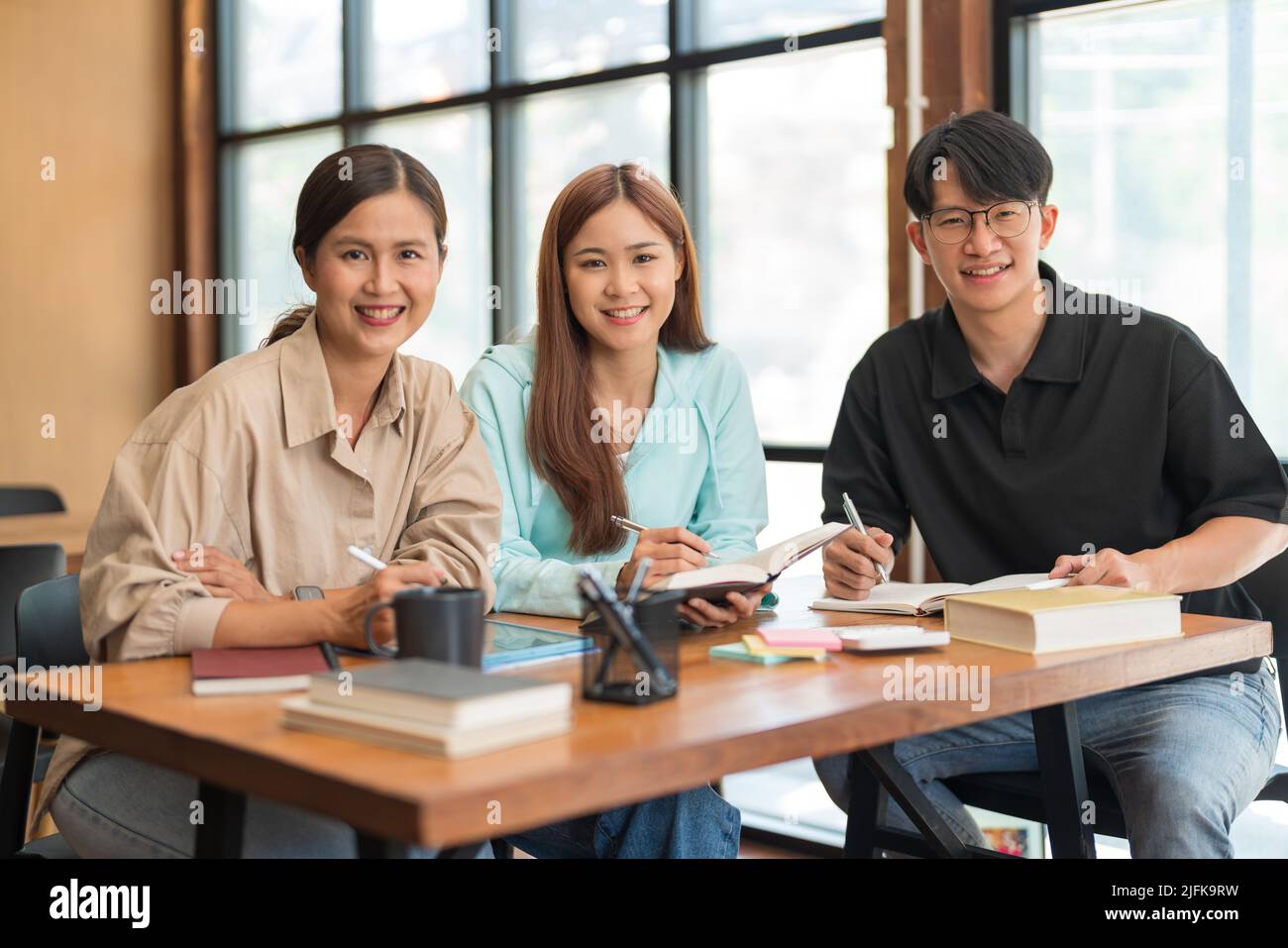 Education concept, Female tutor and students smiling and looking on ...
