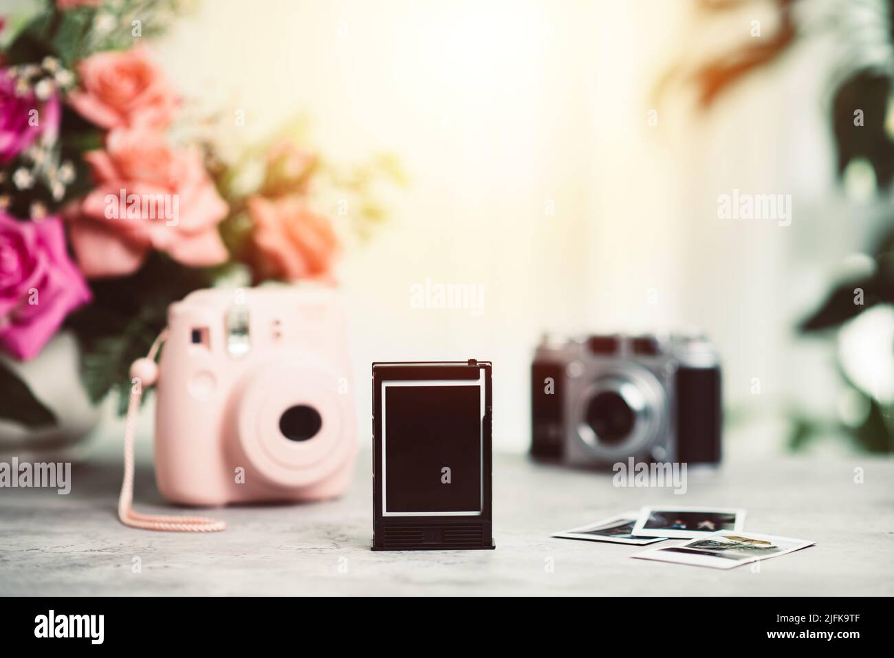 The pink instant camera with blank instant films Stock Photo - Alamy