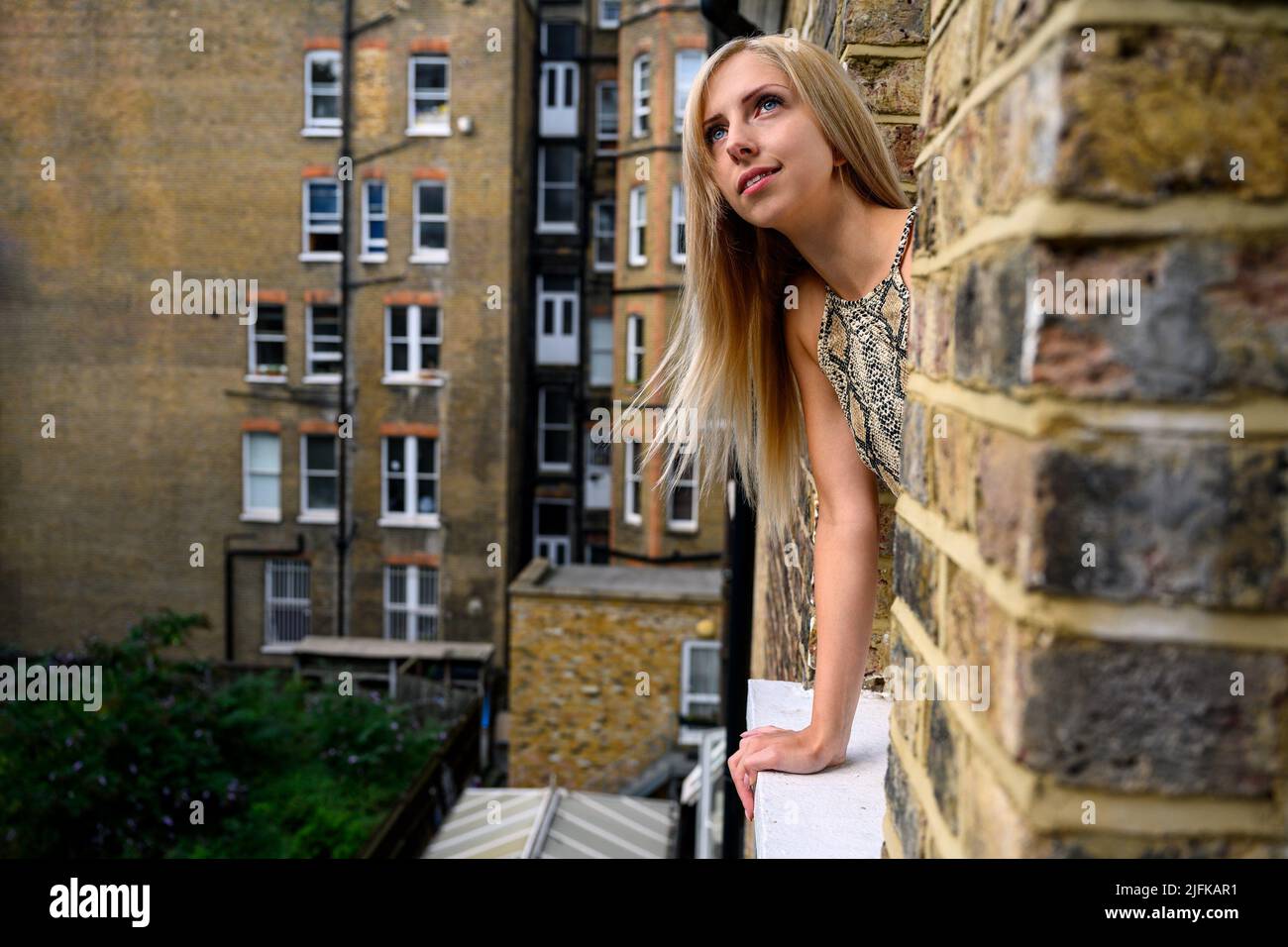 Portrait of young woman with confidence in her eyes, looking out of the ...