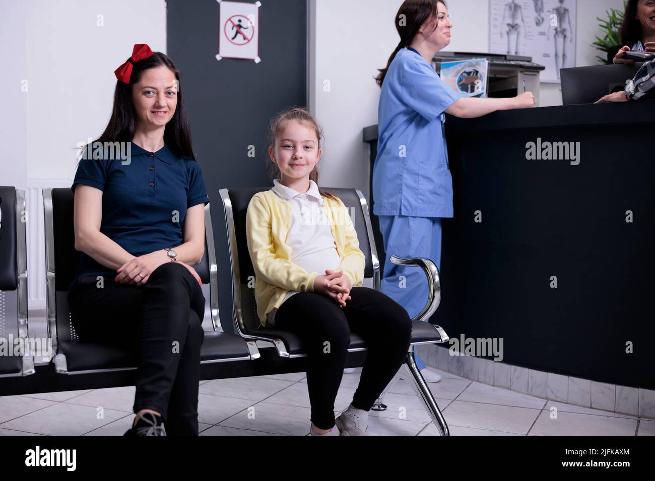 Smiling woman and her child attending pediatrician appointment in ...