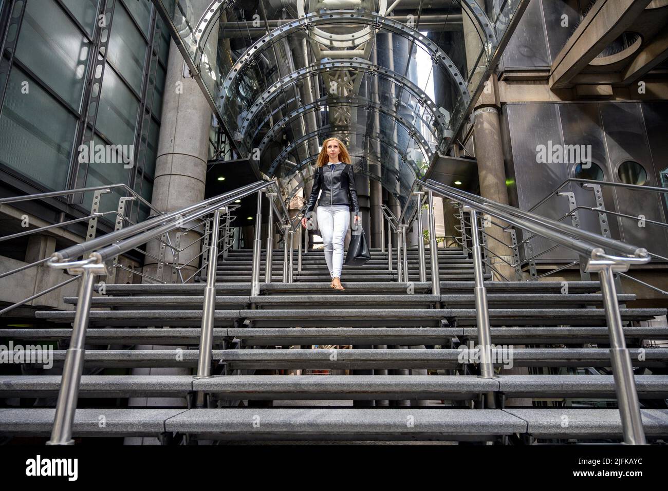 Business woman coming out of building hi-res stock photography and ...