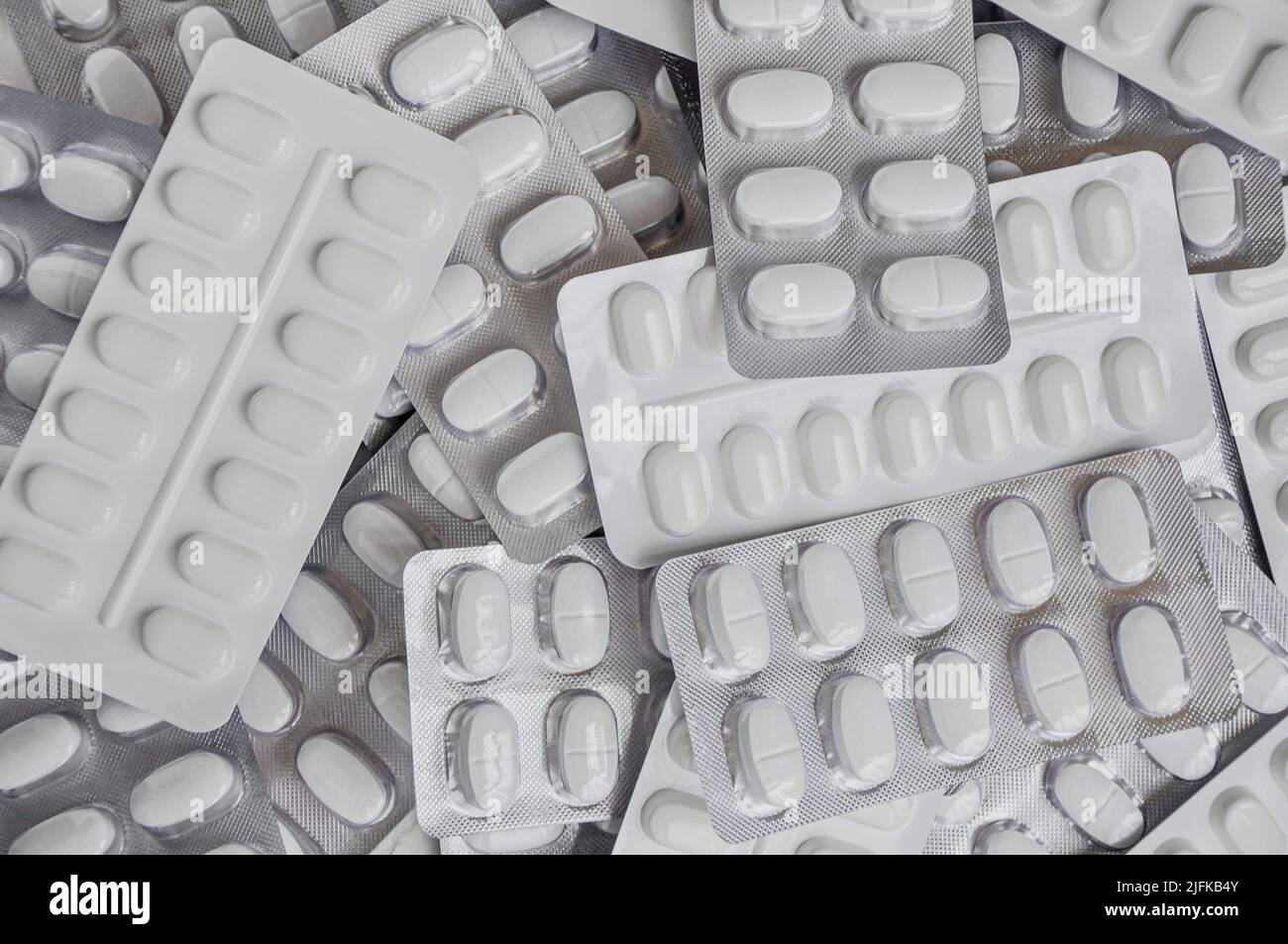 Pharmaceutical medication and medicine pills in packs. White pills in ...