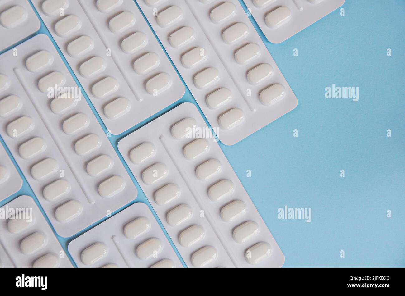 Pharmaceutical medication and medicine pills in packs on blue ...