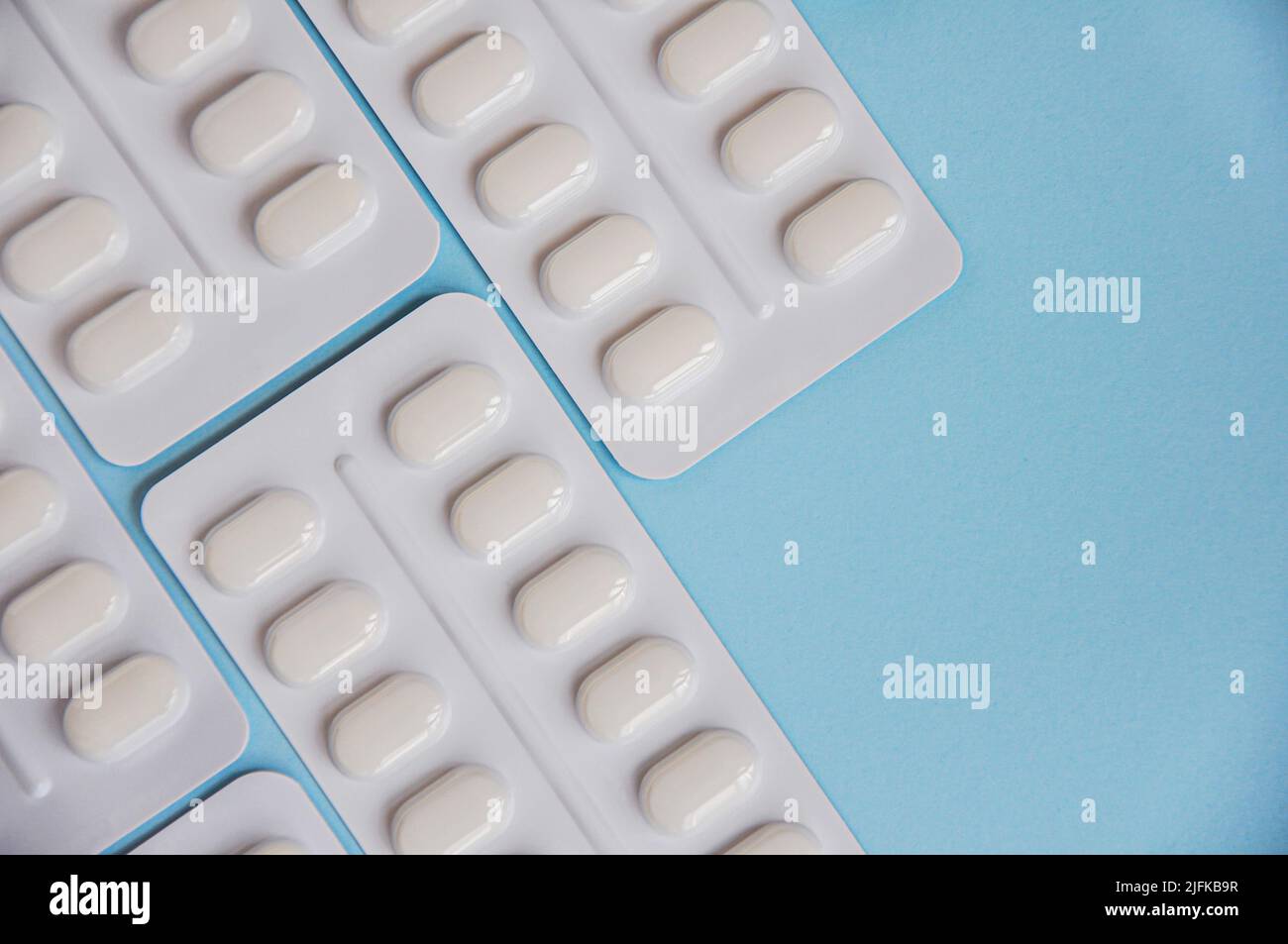 Pharmaceutical medication and medicine pills in packs on blue ...