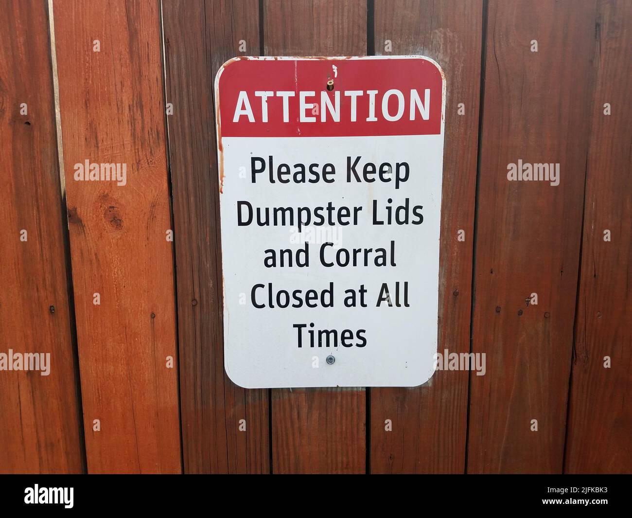 an attention please keep dumpster lids closed sign Stock Photo - Alamy
