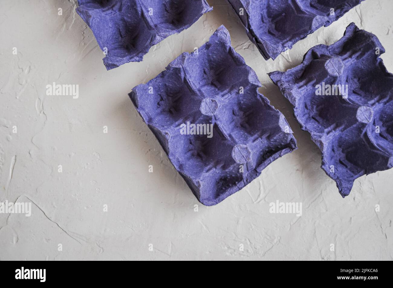 Top view of empty egg cartons, of blue-purple colors, to recycle, on ...