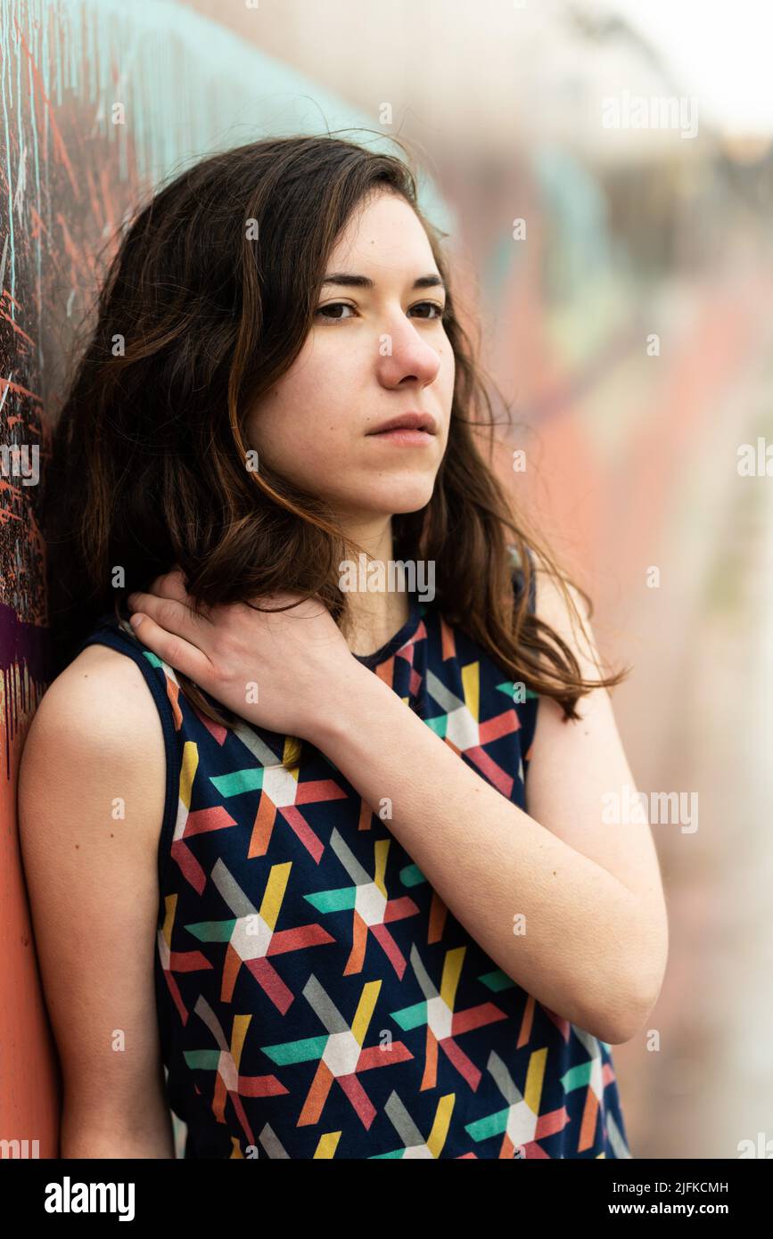 27 year old white woman posing against a colorful wall, arm crossed ...