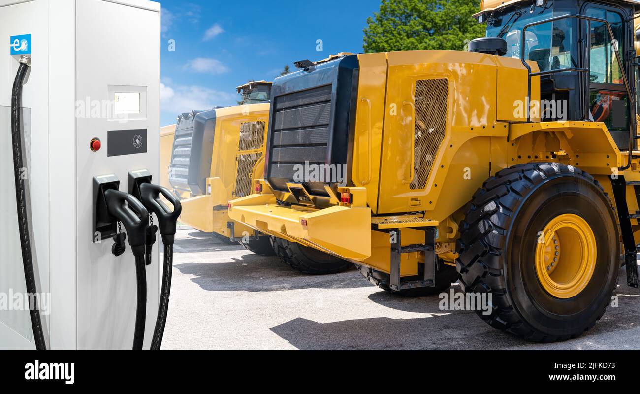 Electric construction machines with charging station. Concept Stock ...