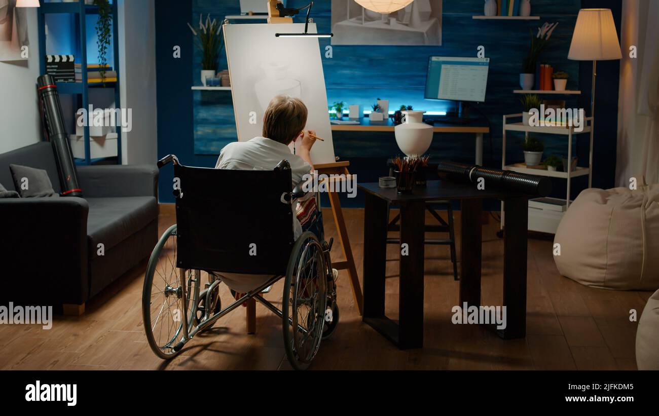 Woman with chronic health condition drawing vase on canvas, using ...