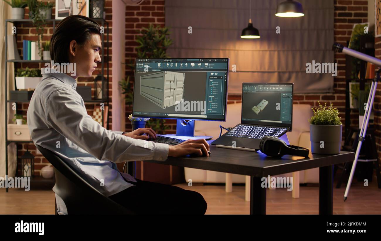 Asian engineer manufacturing industrial product on pc software, using ...