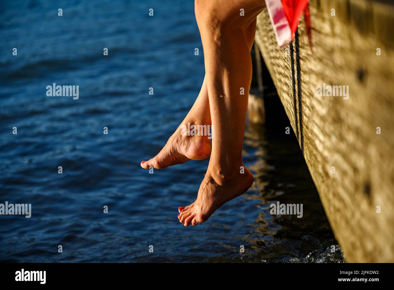 Feet hanging off pier hi-res stock photography and images - Alamy