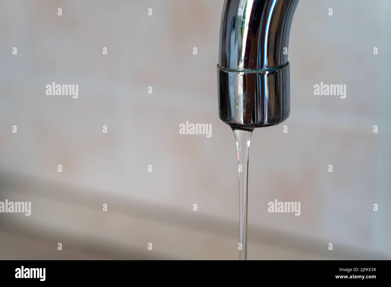 Tap from which drops of water flow. Drought, shortage, rationing and ...