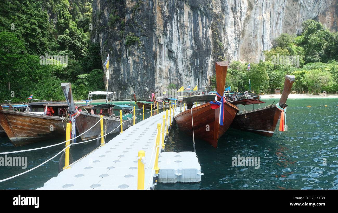 Long tail boat with natural landscape of green mountain cliff and ...