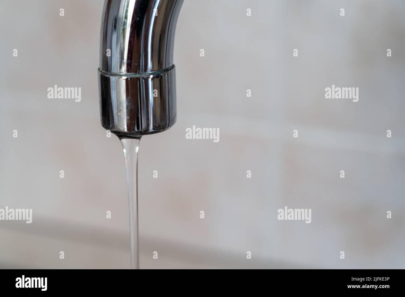 Tap from which drops of water flow. Drought, shortage, rationing and ...