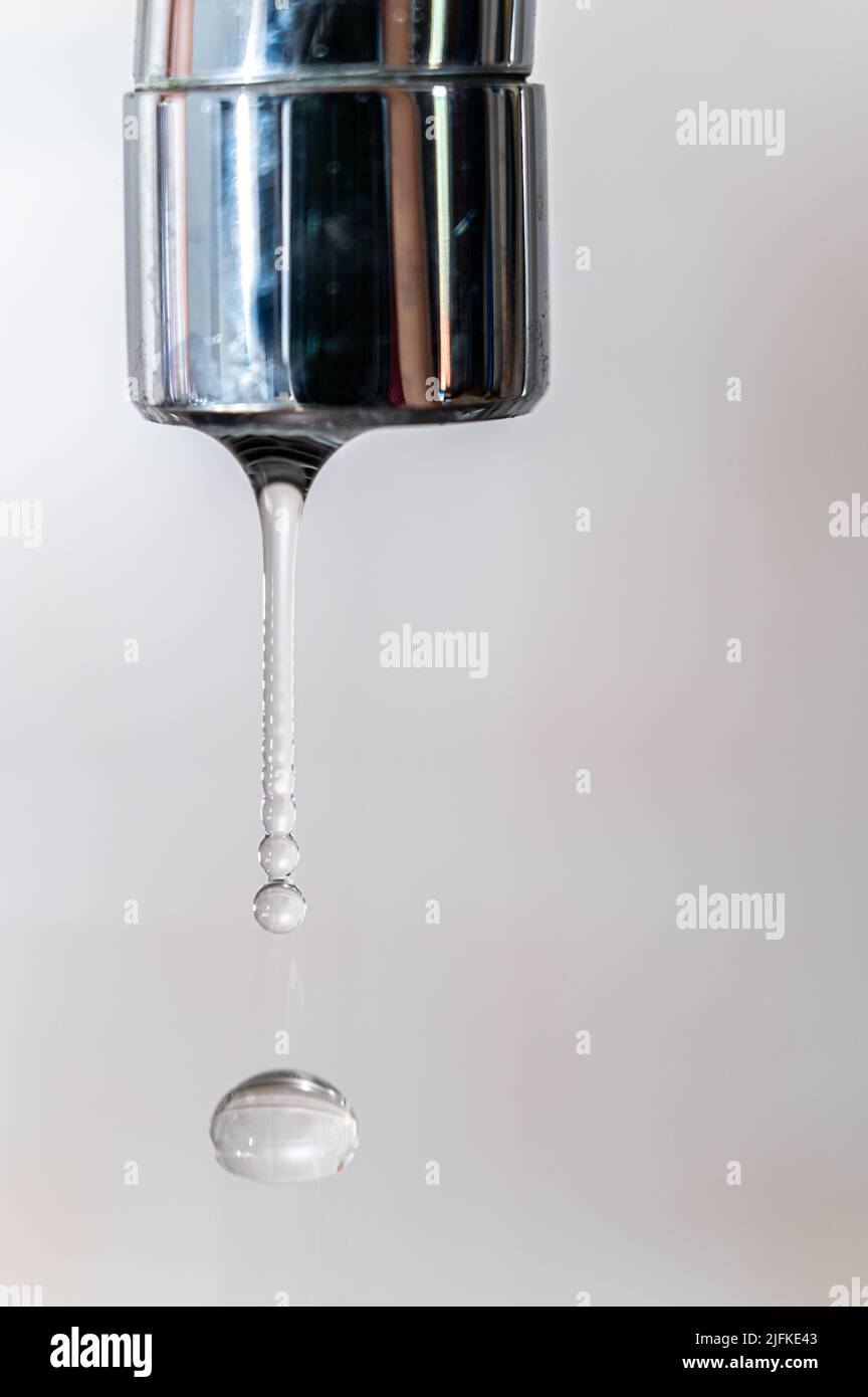 Tap from which drops of water flow. Drought, shortage, rationing and ...