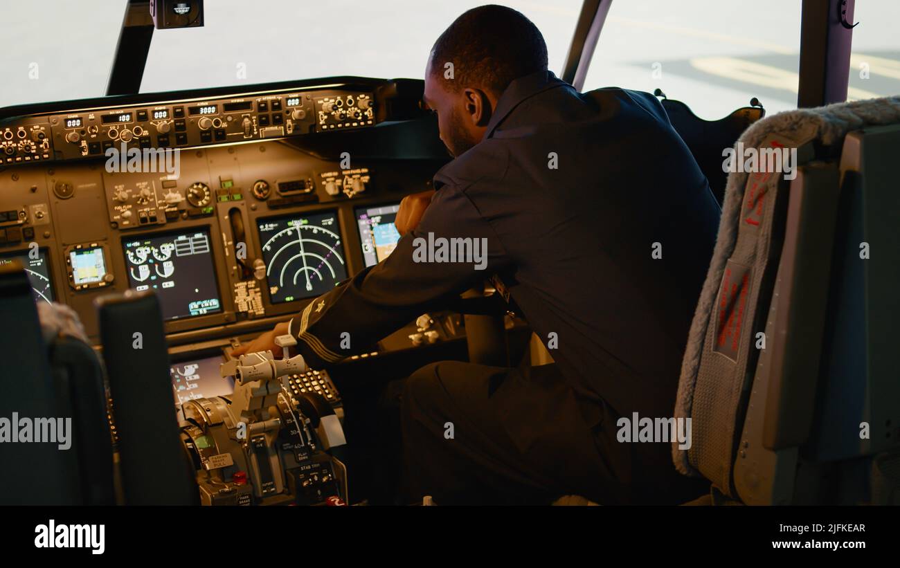 African american captain inserting destination coordinates on control ...