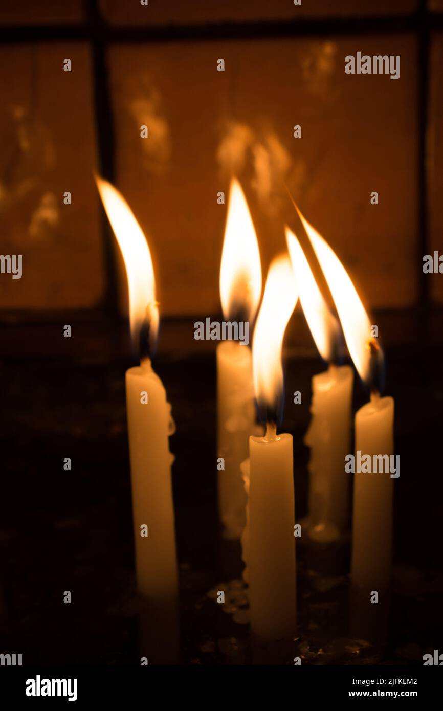 Burning candles with candle light in the dark Stock Photo - Alamy