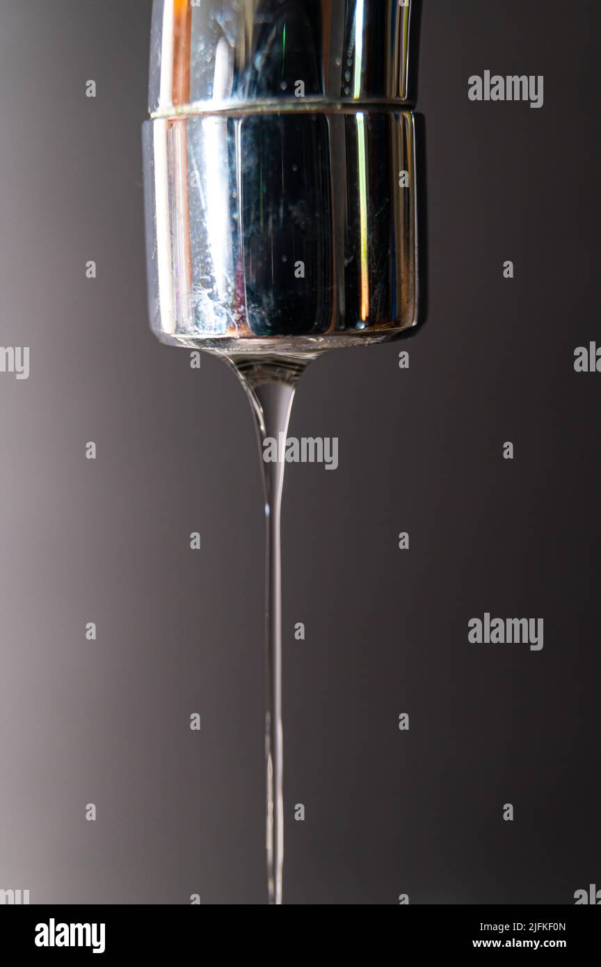 Tap from which drops of water flow. Drought, shortage, rationing and ...