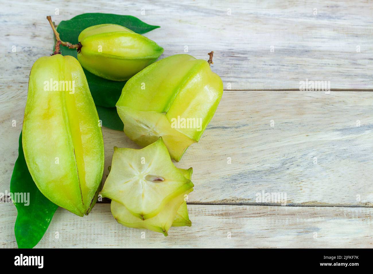 Close up star fruit carambola or star apple ( starfruit ) on wood table ...