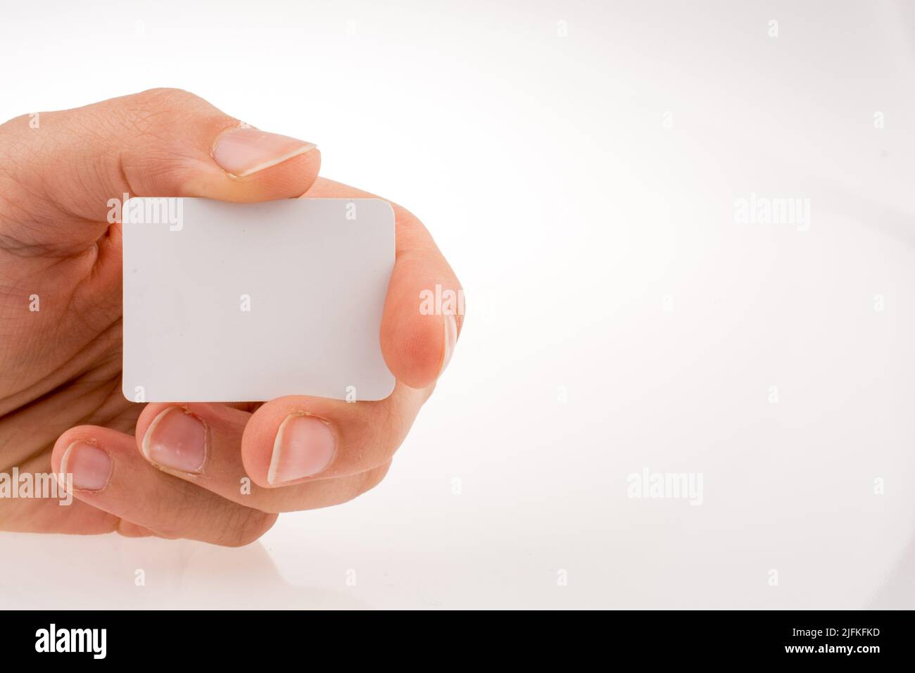 Hand holding a piece of paper on a white background Stock Photo - Alamy