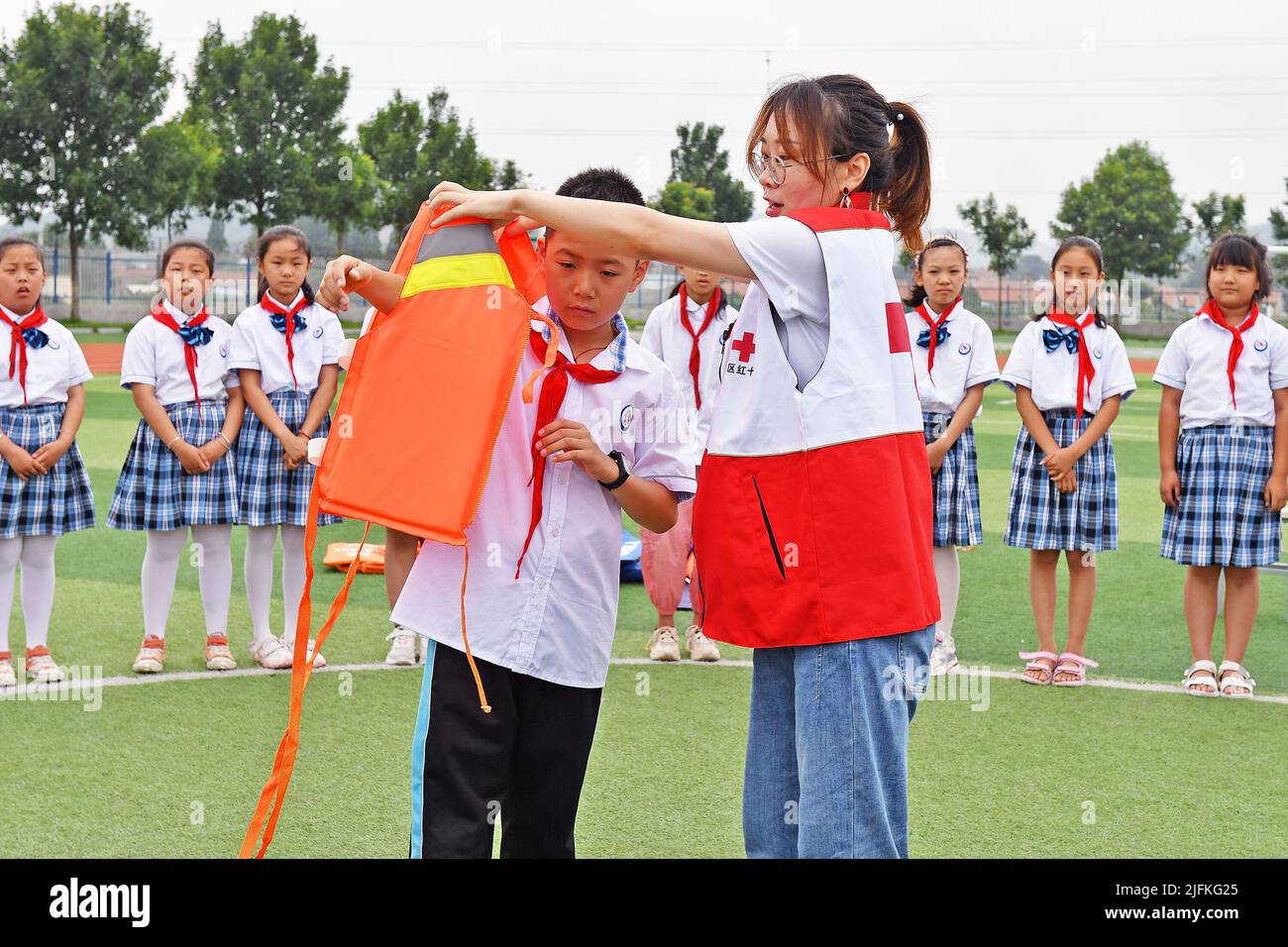 YANTAI, CHINA - JULY 4, 2022 - Red Cross volunteers guide students to ...