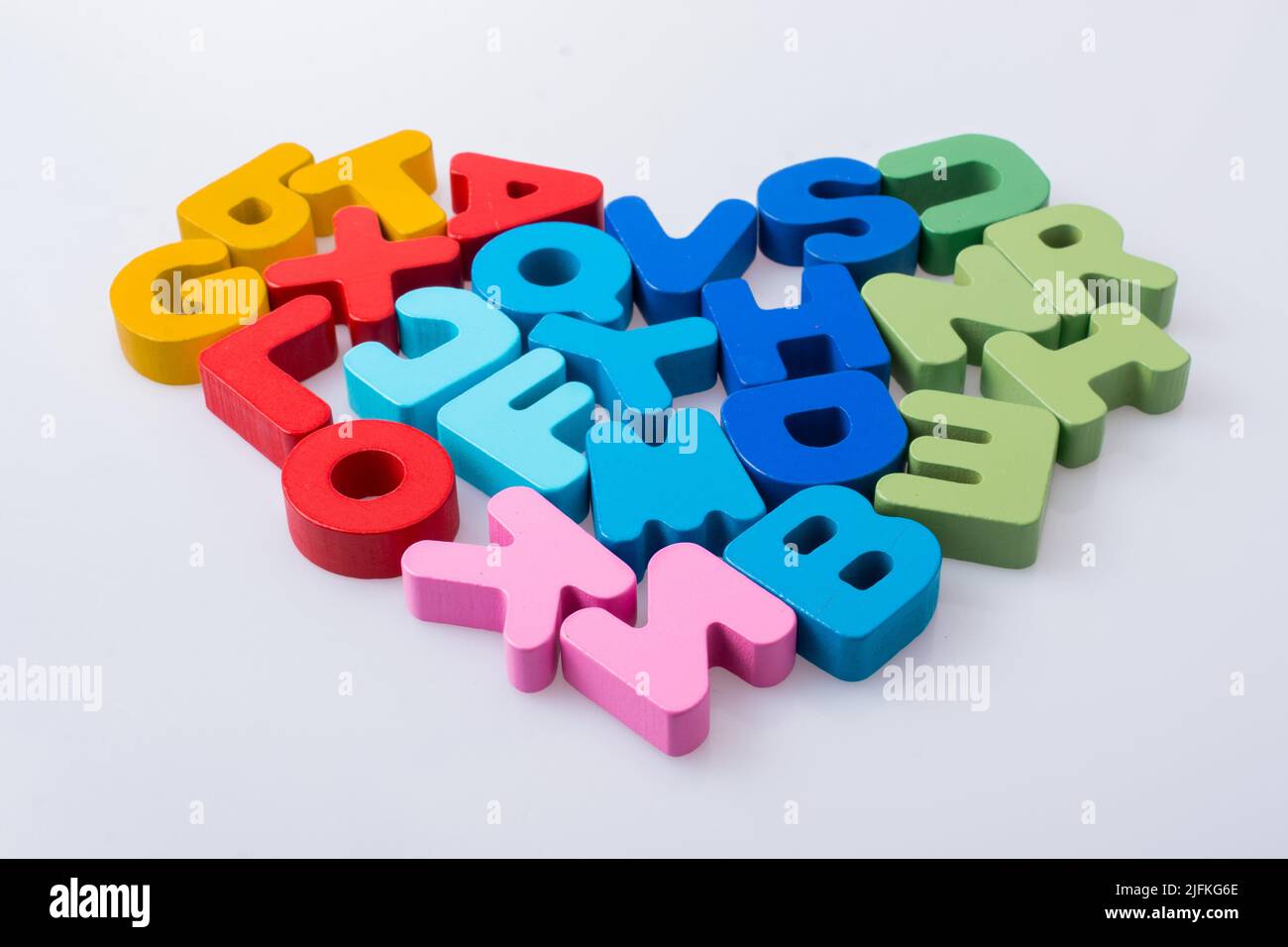 Colorful letter blocks shape heart on white background Stock Photo - Alamy