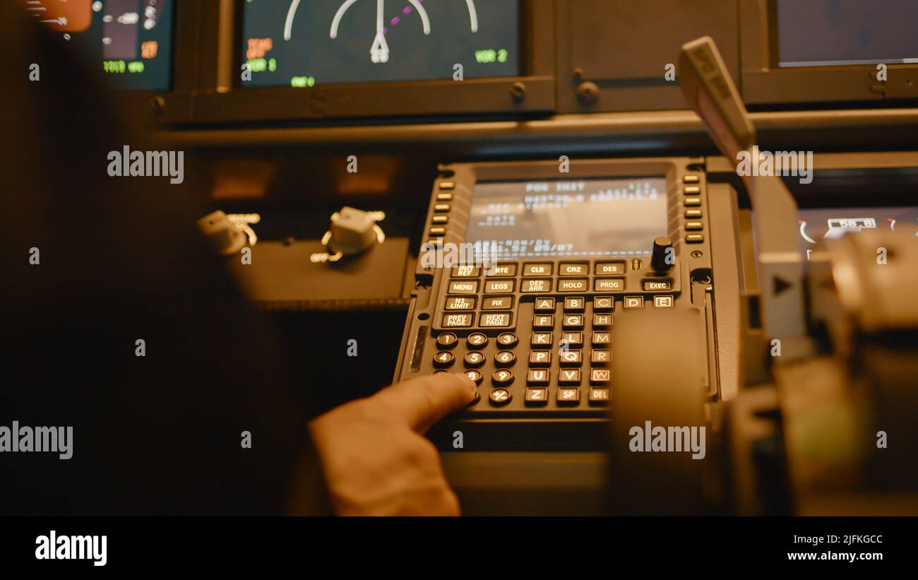 Plane captain using dashboard buttons to insert coordinates, flying ...